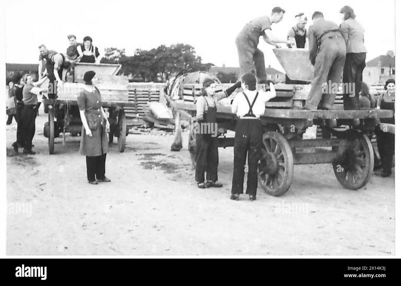 SOLDIERS HELP IN INDUSTRY - The soldiers helping to load the huts on to ...