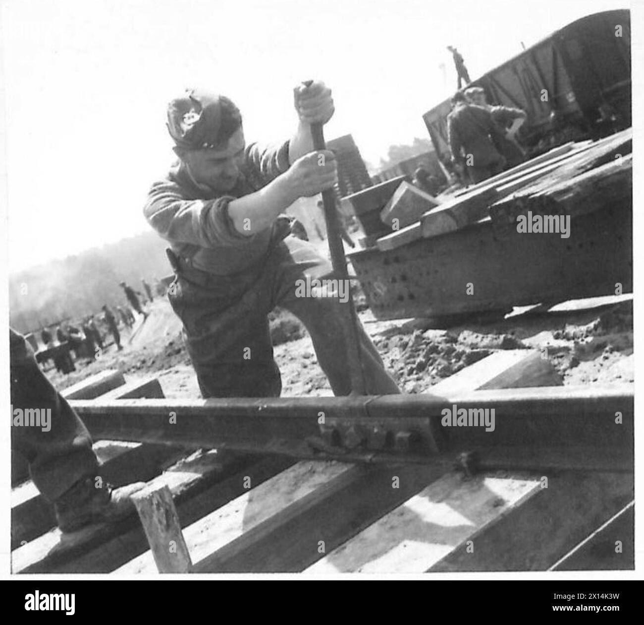 A MILITARY RAILWAY FOR TRAINING R.Es. - An army platelayer bolting the ...
