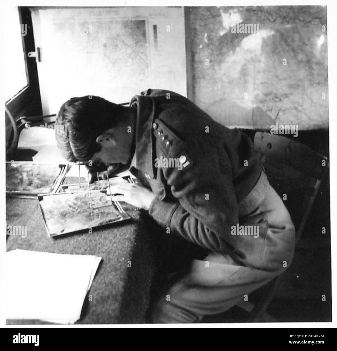 Capt. P.H. Flint, Officer Commanding of A.A.I.P.U., examines ...