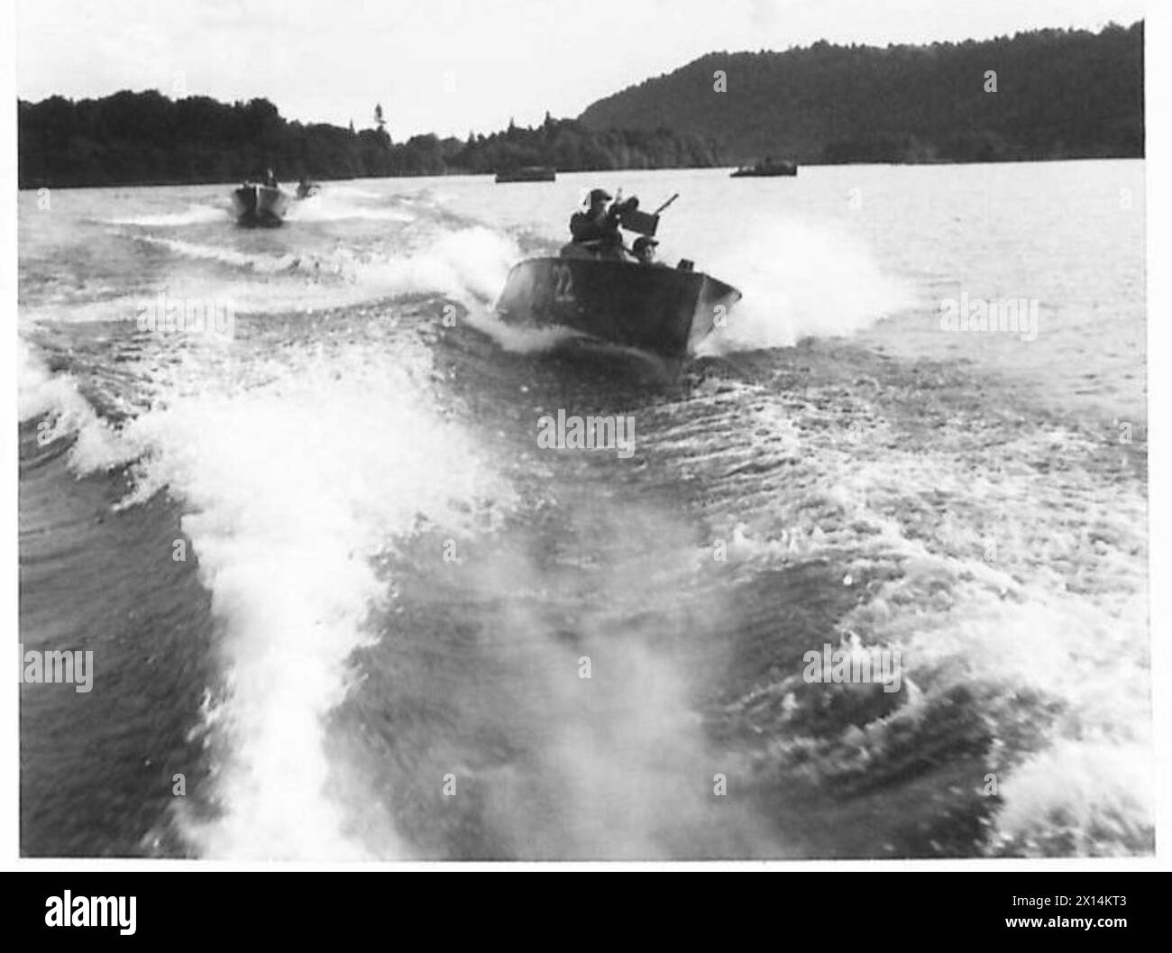 Home Guard personnel operate speed boats equipped with machine guns ...