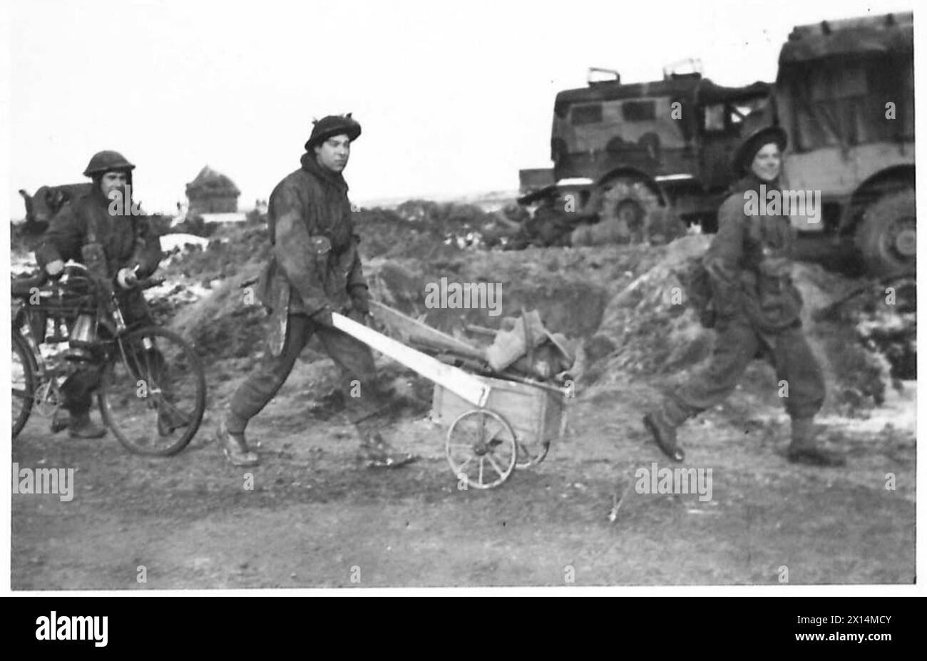 12 CORPS ATTACK - An infantryman wheeling his kit on a pushcart British ...
