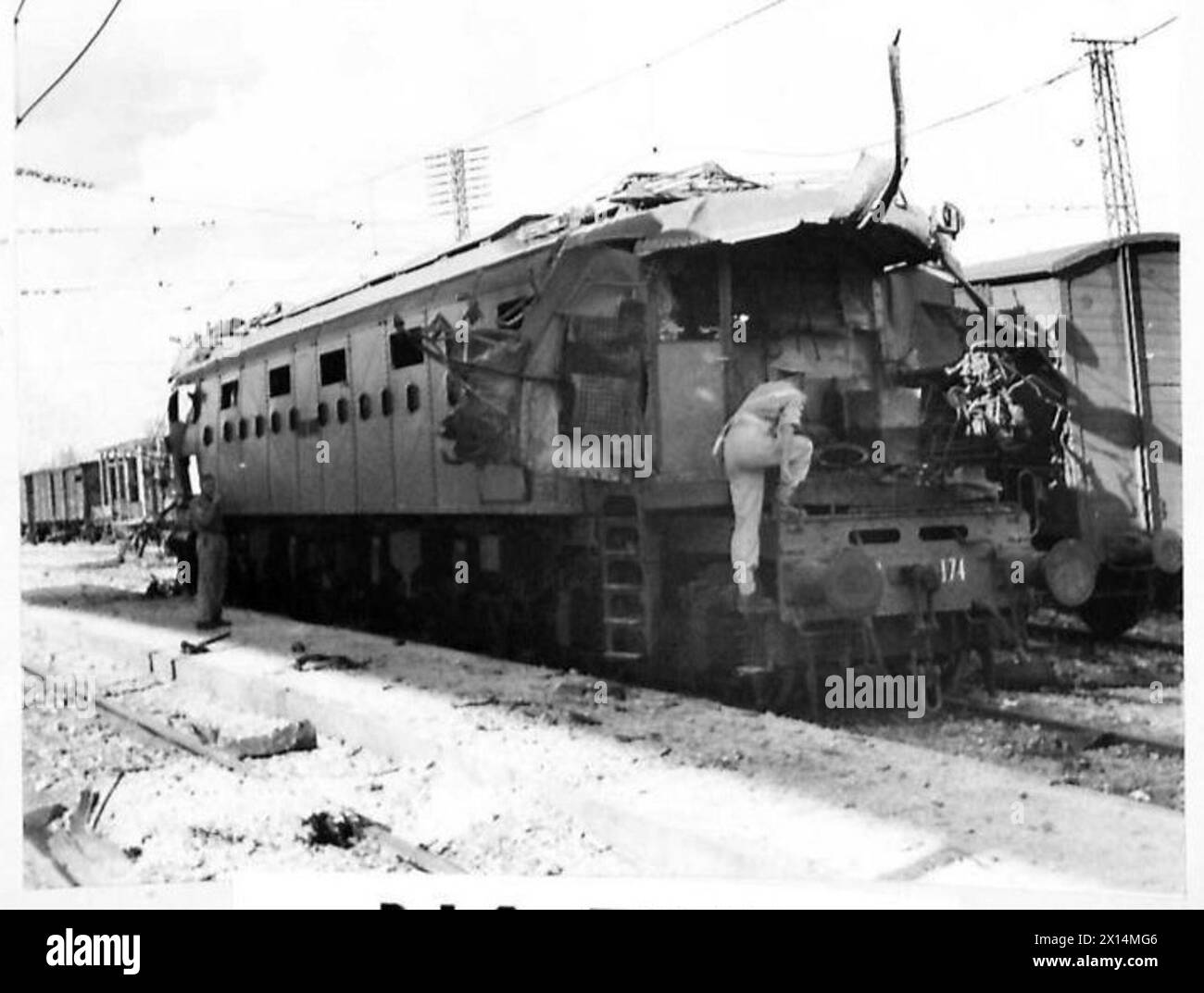 British soldiers inspect a destroyed Italian electric locomotive at ...