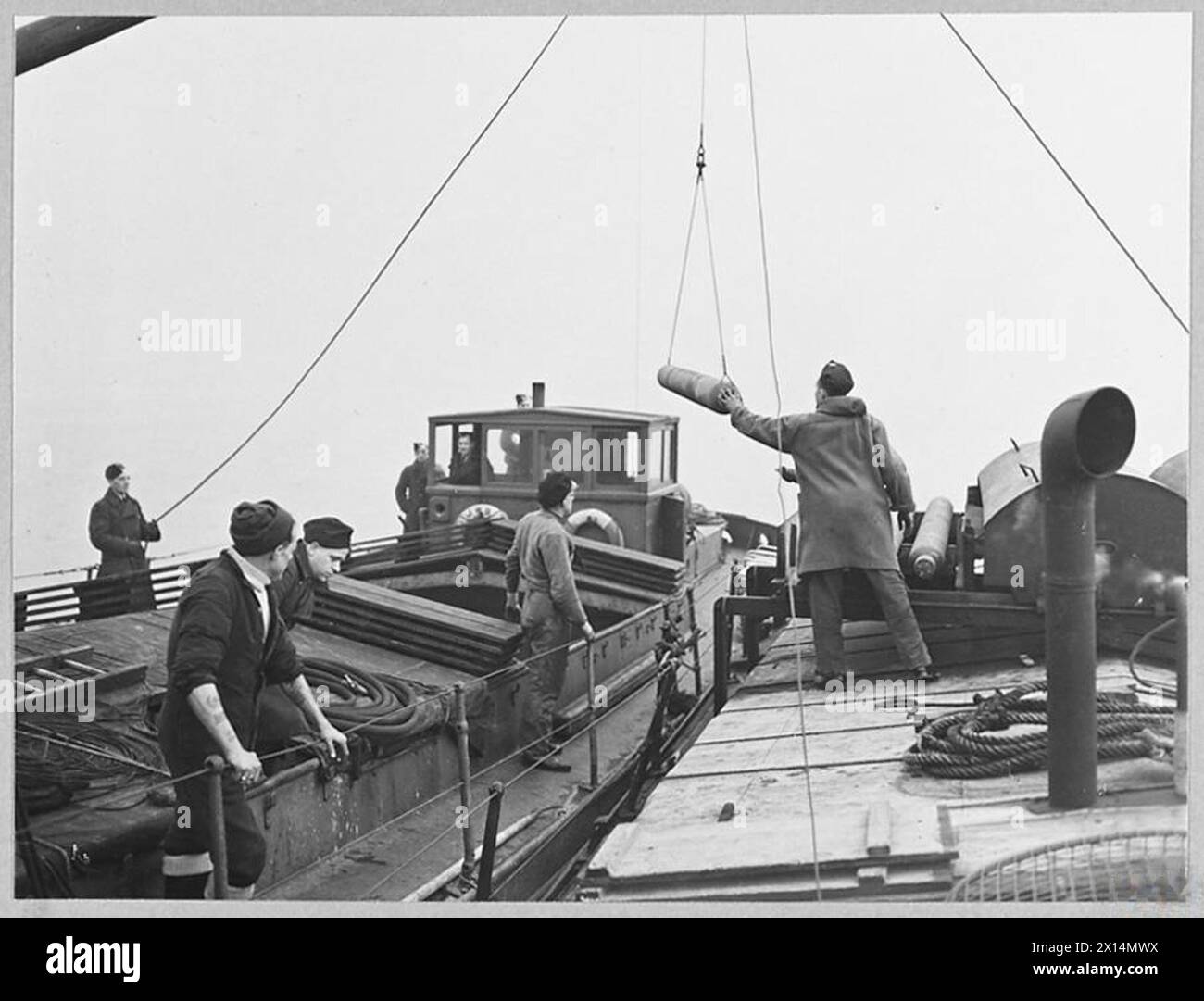 Photograph showing a barrage balloon being transferred to the ship ...