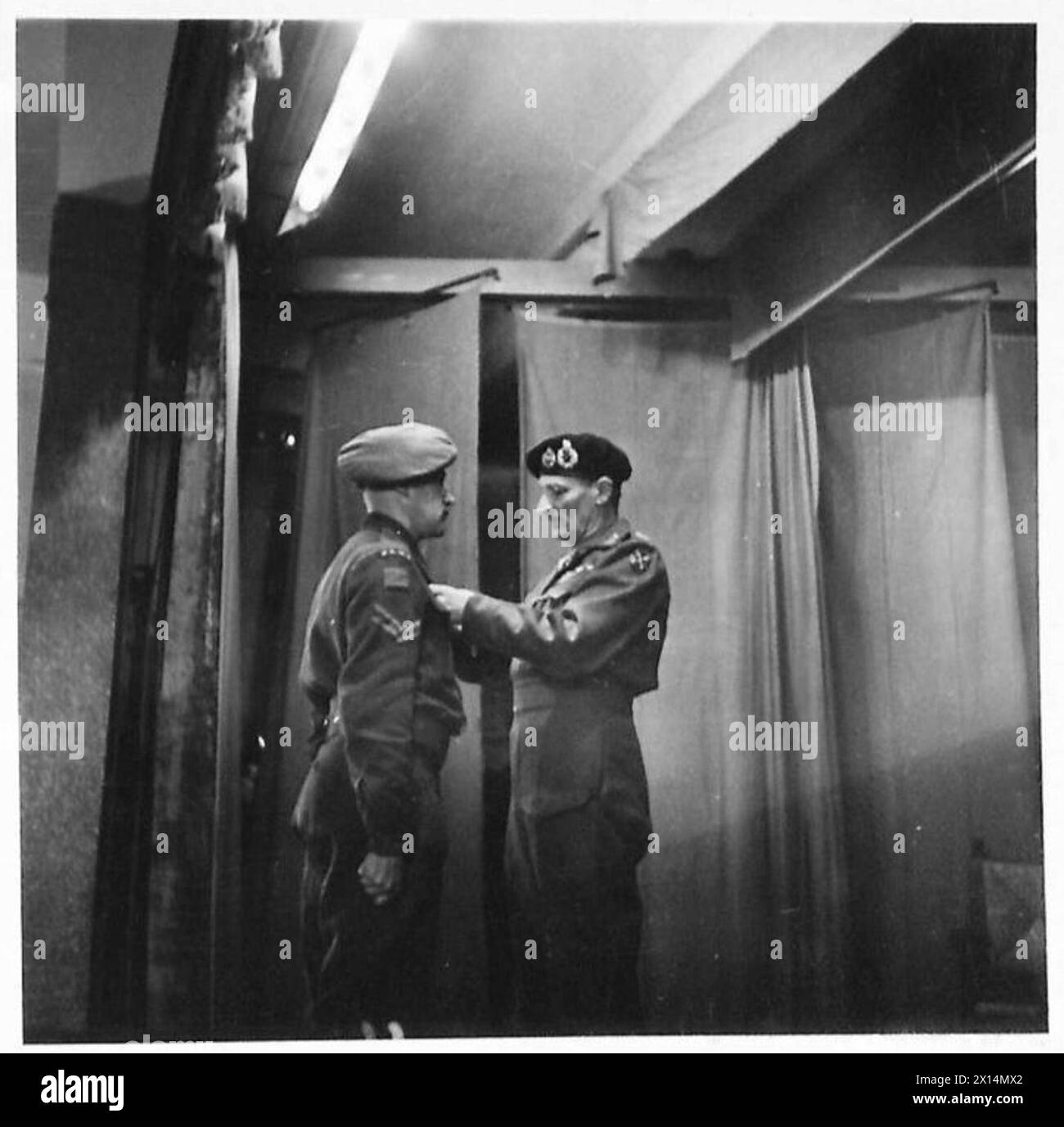 Colonel F.V. Gleeson of the 212 Field Ambulance, RAMC, receives the ...