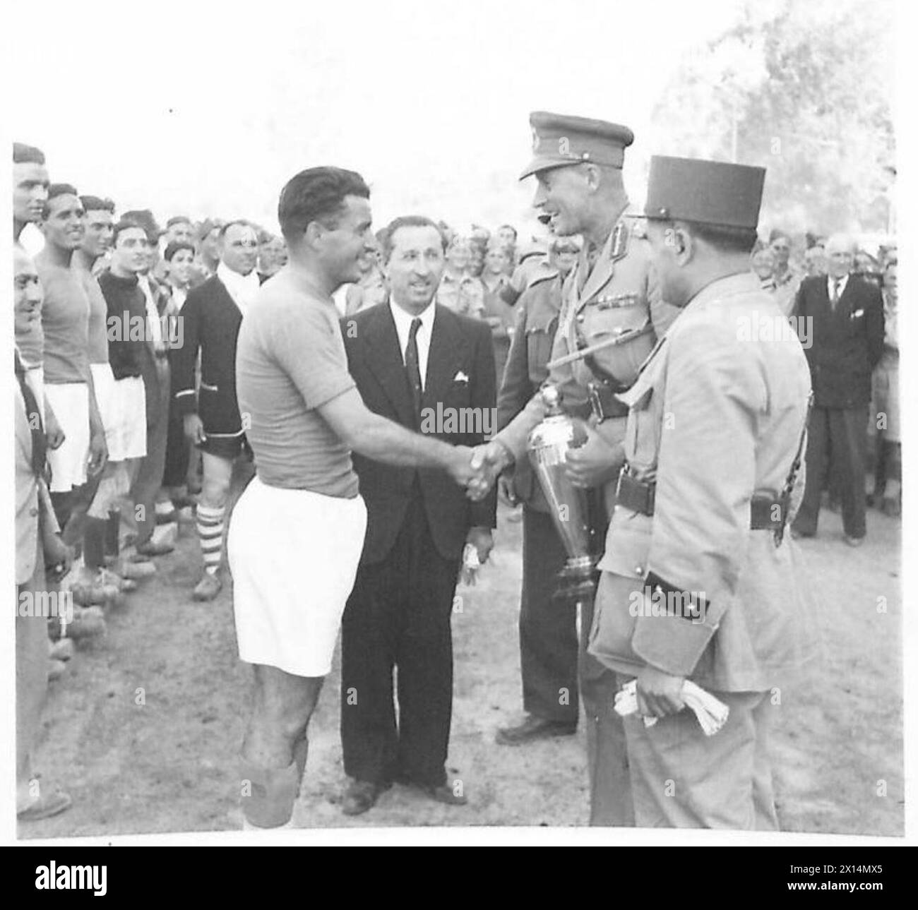 Major General Freeman-Attwood presents a football cup to Azzopardi ...