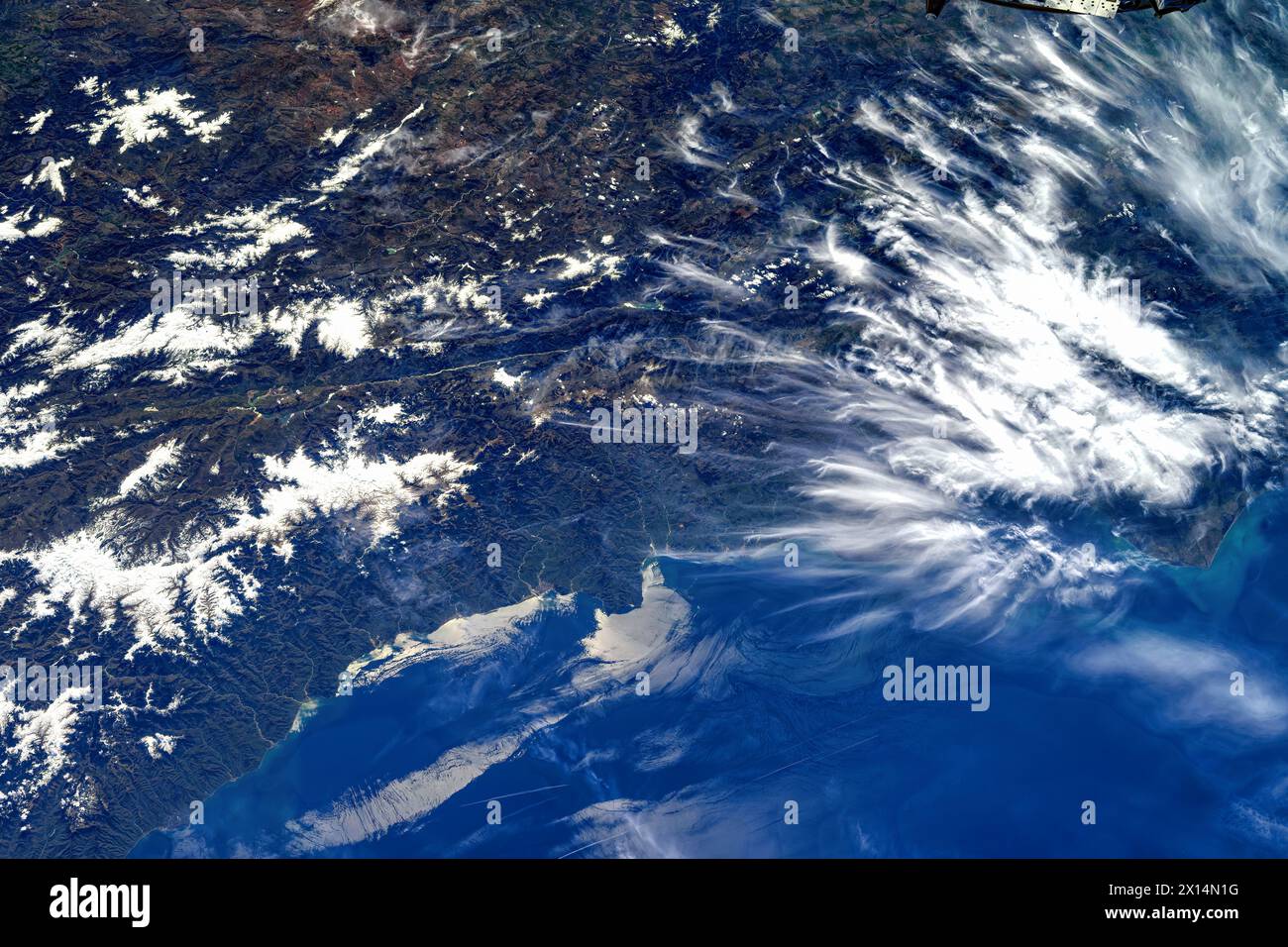 Clouds and coastline in the Pacific Ocean. Digital enhancement of an ...