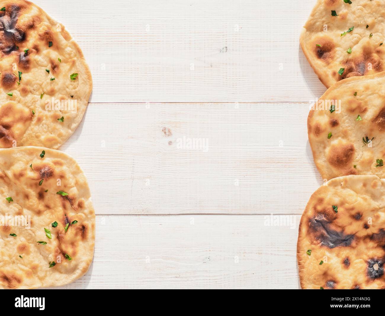 Pattern of fesh naan bread on white wood background with copy space in ...