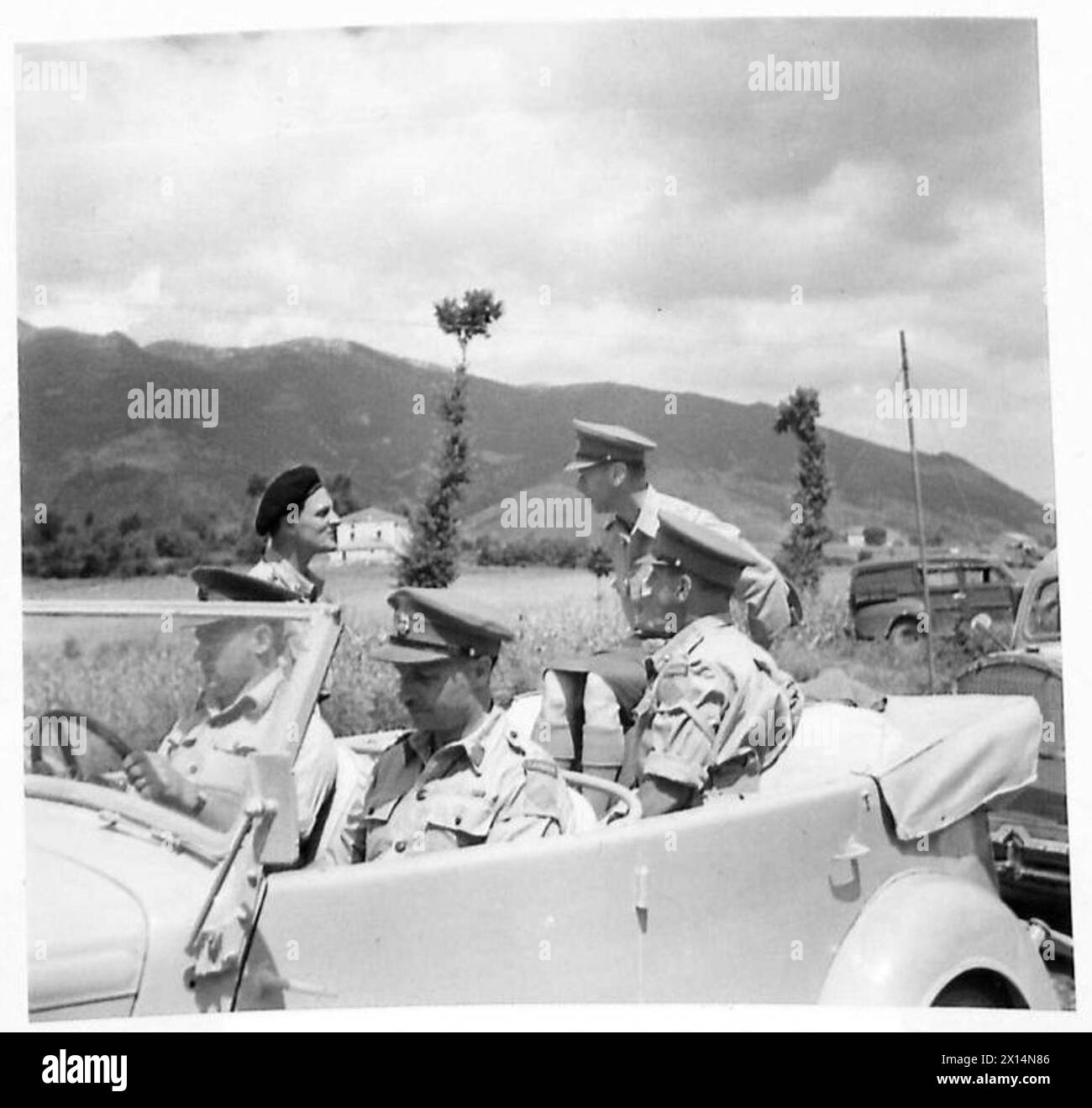 H.M. THE KING WITH THE CANADIANS - H.M. the King speaking to an officer ...