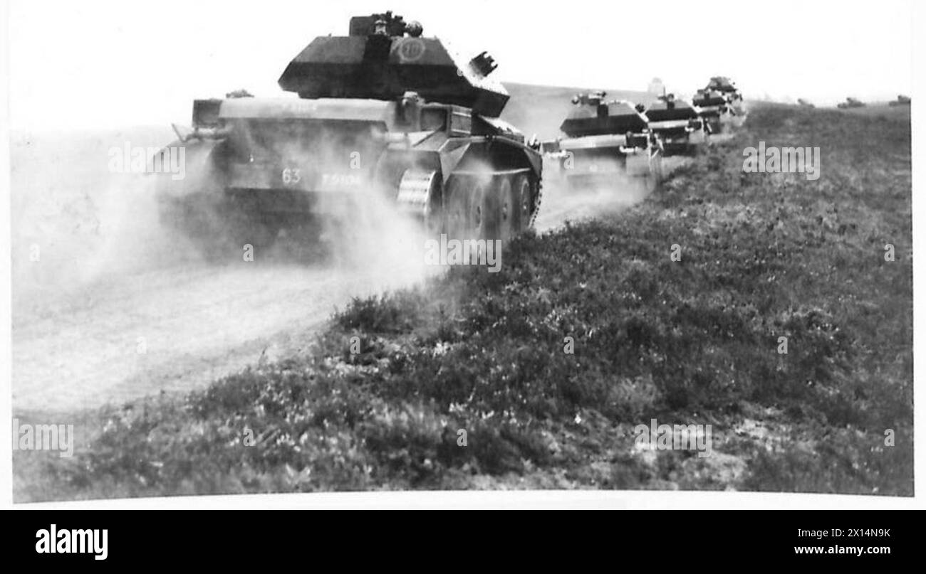 A DAY WITH THE ROYAL TANK REGIMENT - A line of tanks crossing a common ...