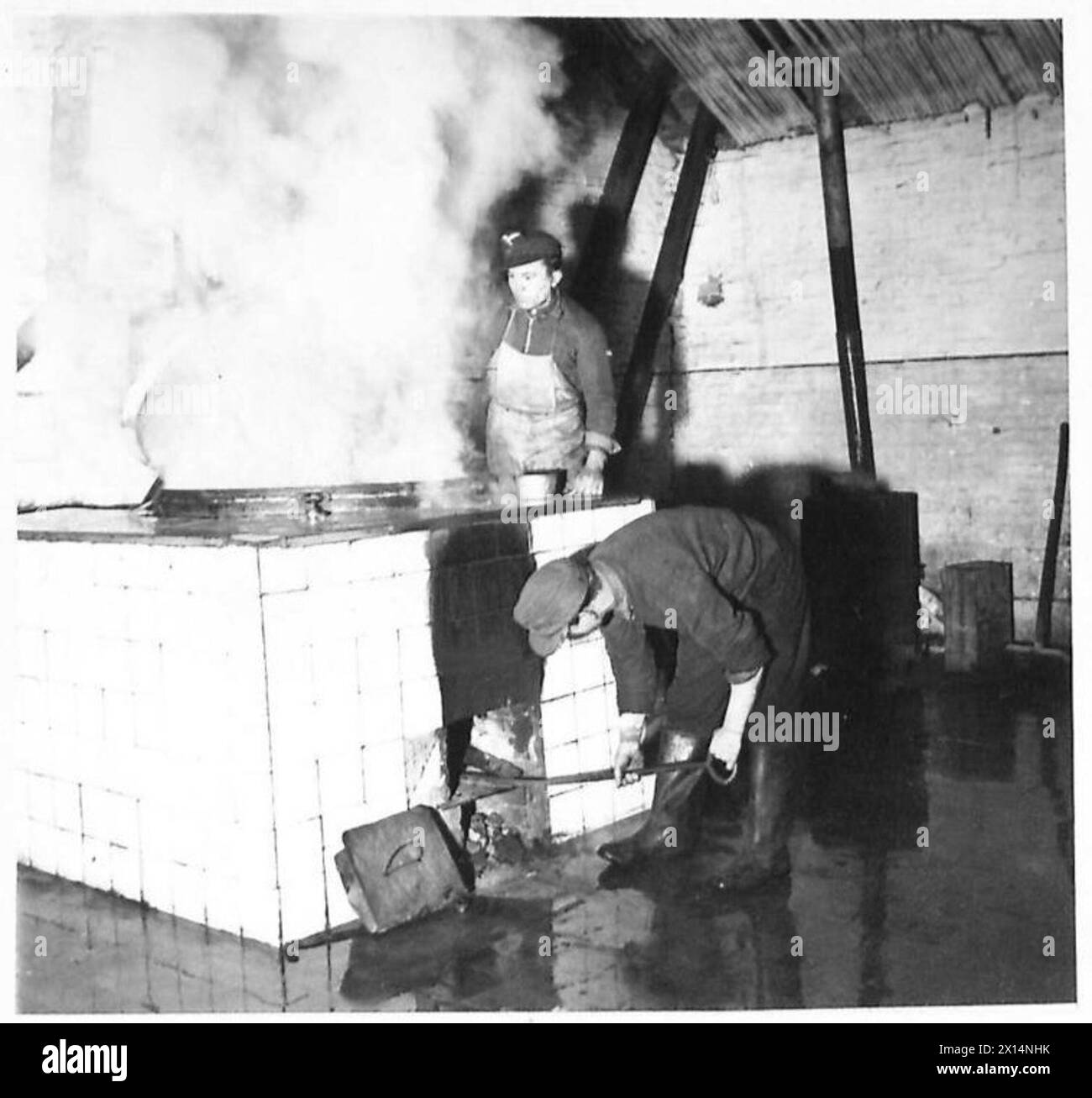 PS. C W - German cooks preparing a hot meal in one of the camp kitchens ...