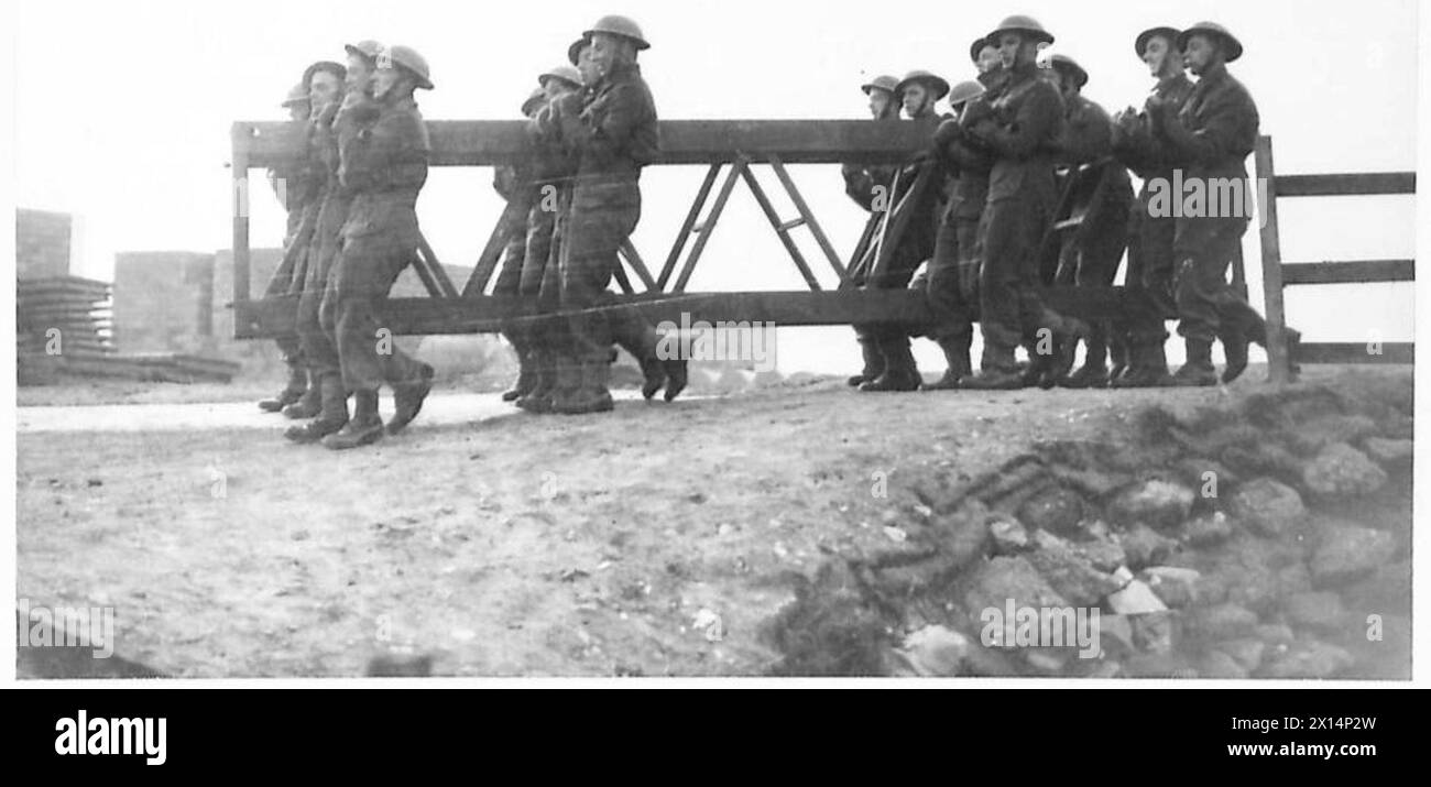 Sappers of the British Army carrying a section of a temporary bridge ...