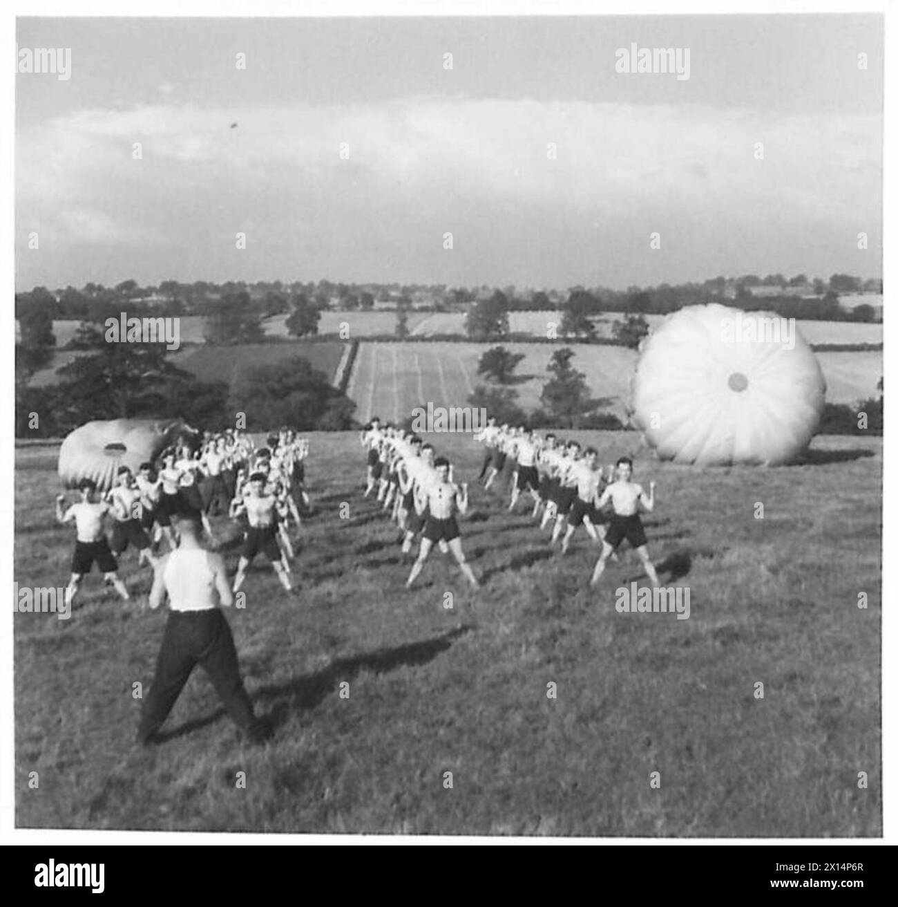A physical training squad performs exercises at the Parachute Training ...