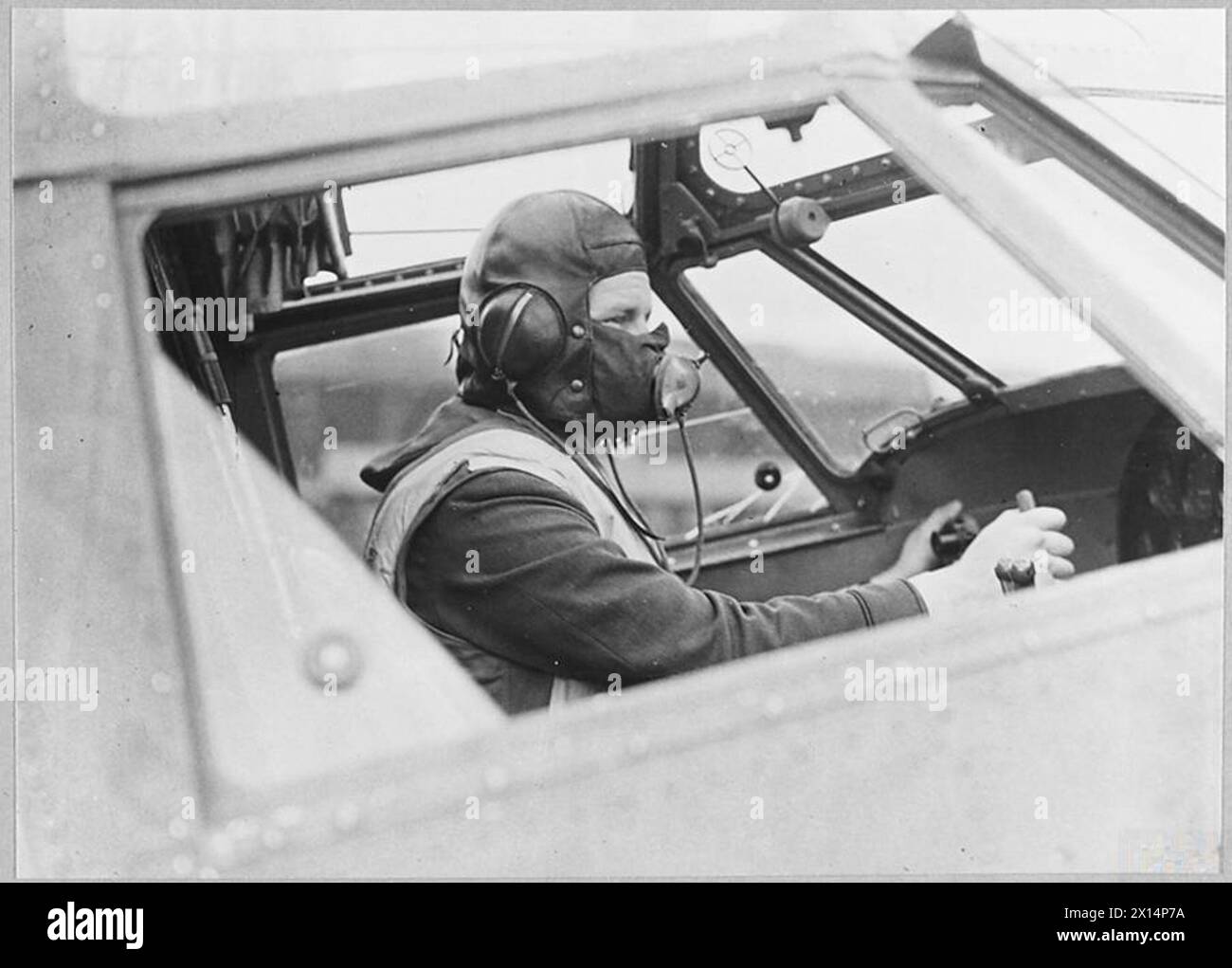 A Hudson aircraft pilot waits at the controls for the take-off signal ...