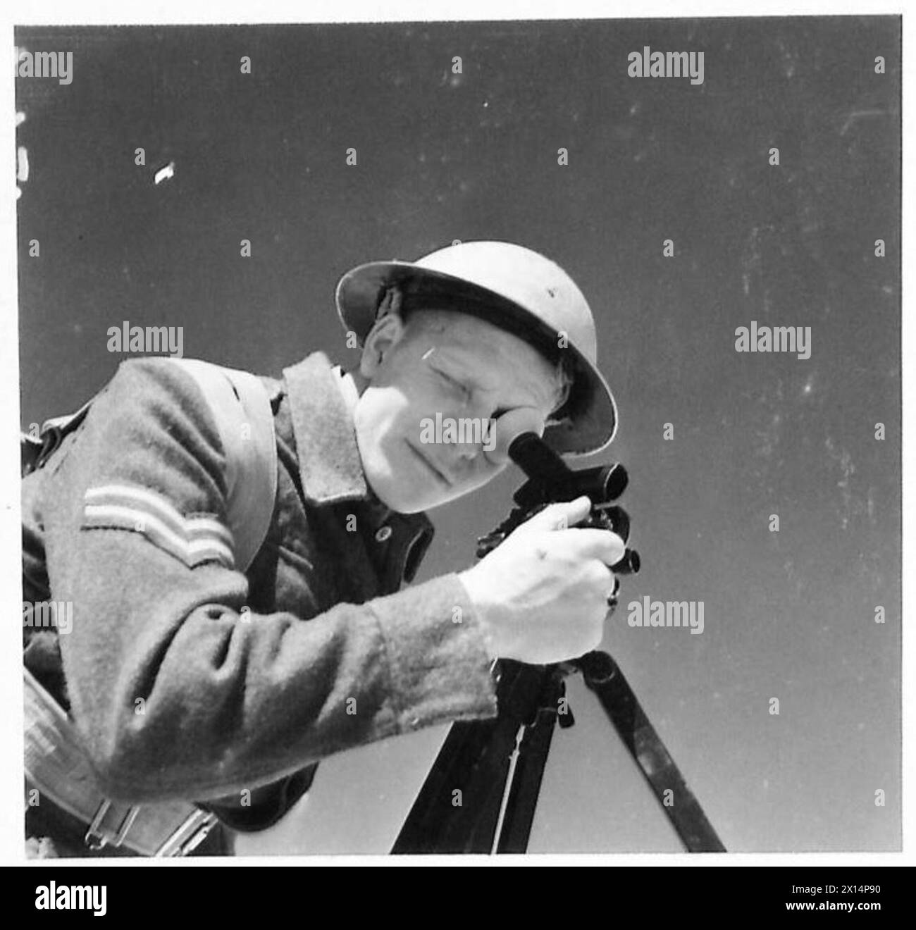 A Gunner Bombadier surveys the terrain after landing in North Africa or ...