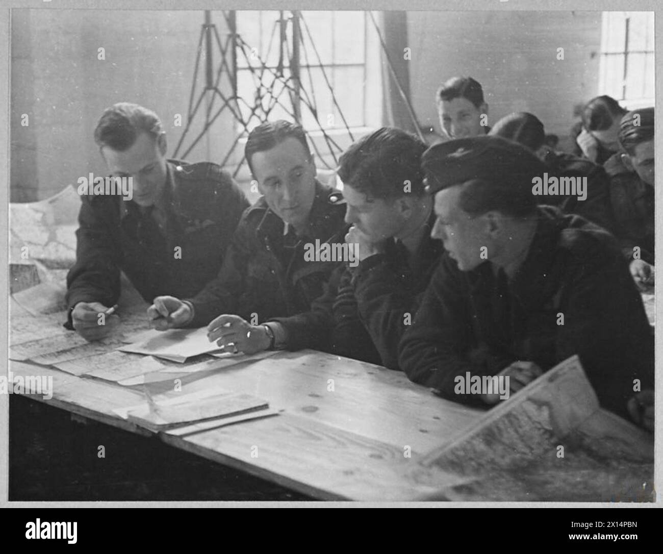 RAF pilots study a map for paratroop drop zones as part of combined ...