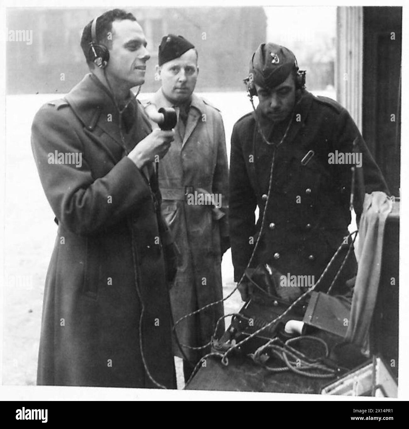 A demonstration for factory workers shows a field telephone in use ...