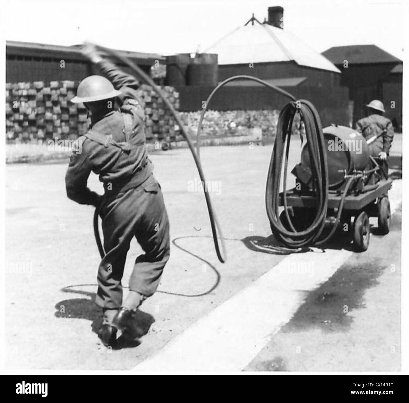 ARMY FIREMEN - The foam engine is wheeled out and the hose uncoiled ...