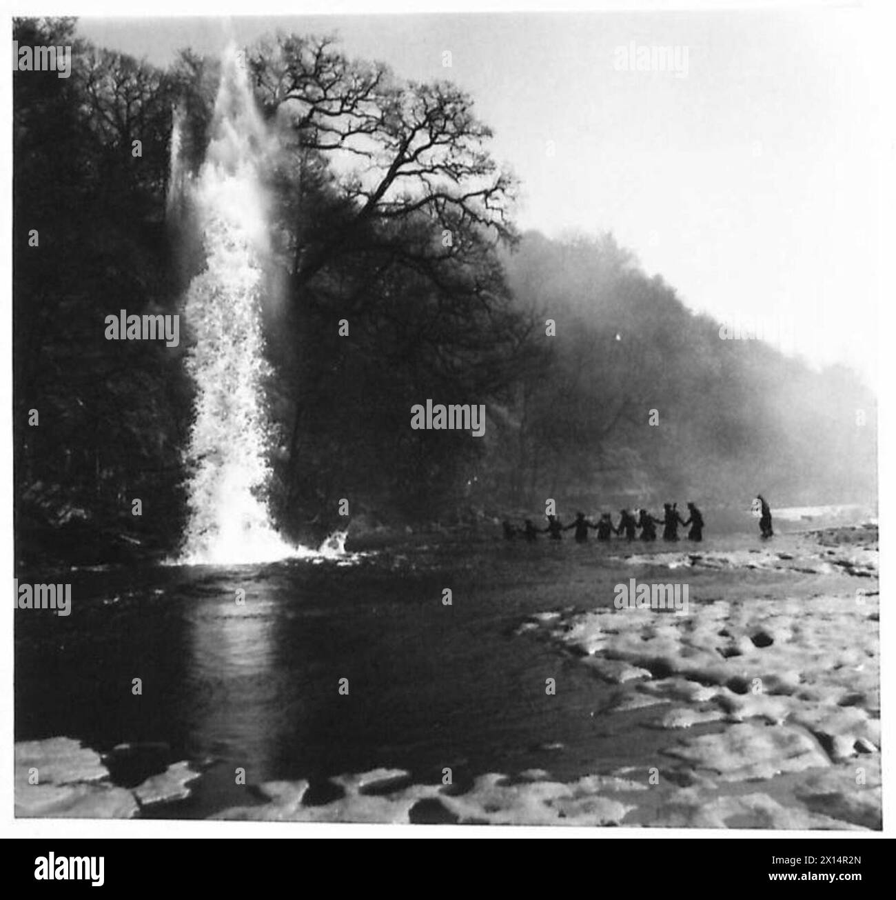 GENERALS VISIT BATTLE SCHOOL - Infantry cross a stream under a heavy ...