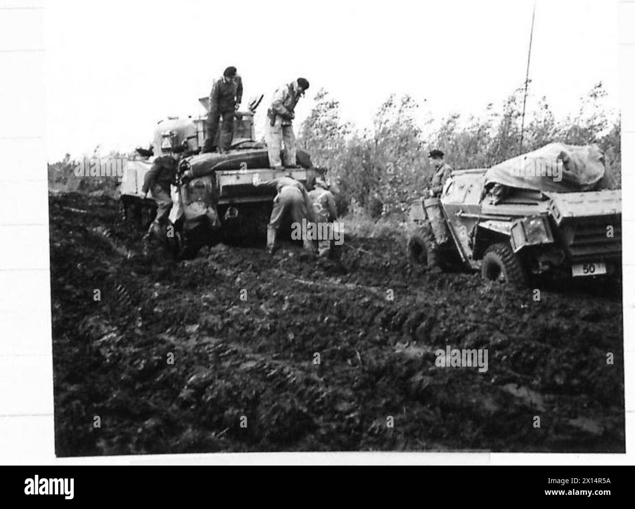 WEATHER CONDITIONS - A tank comes to the rescue to pull outa Dingo ...