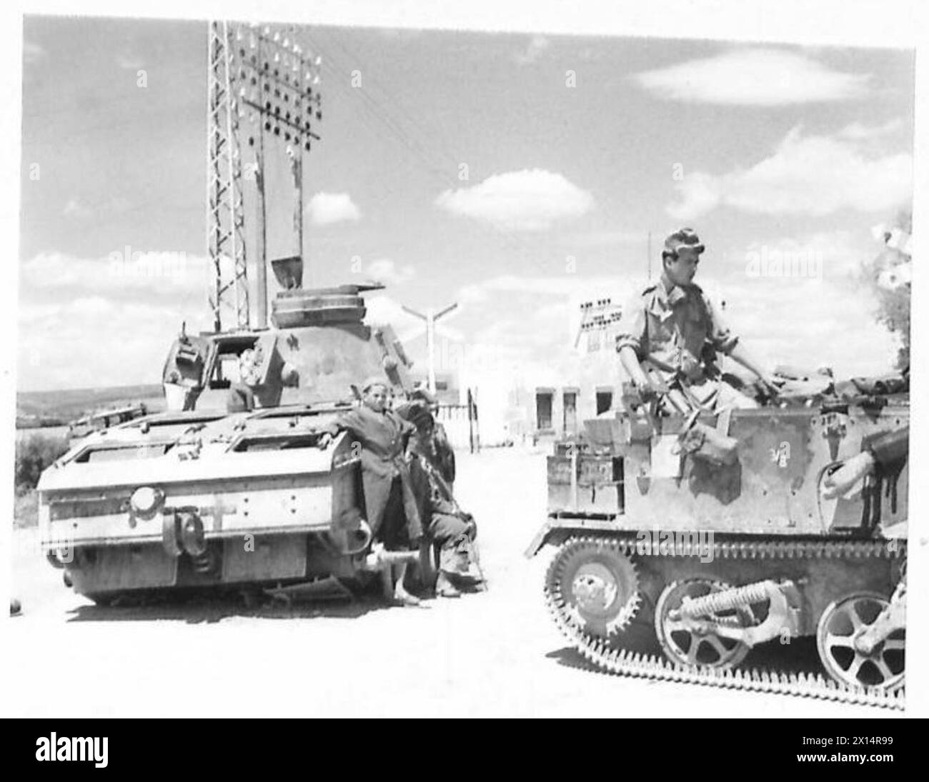 In Tebourba, local Arab civilians observe a British Army Bren carrier ...