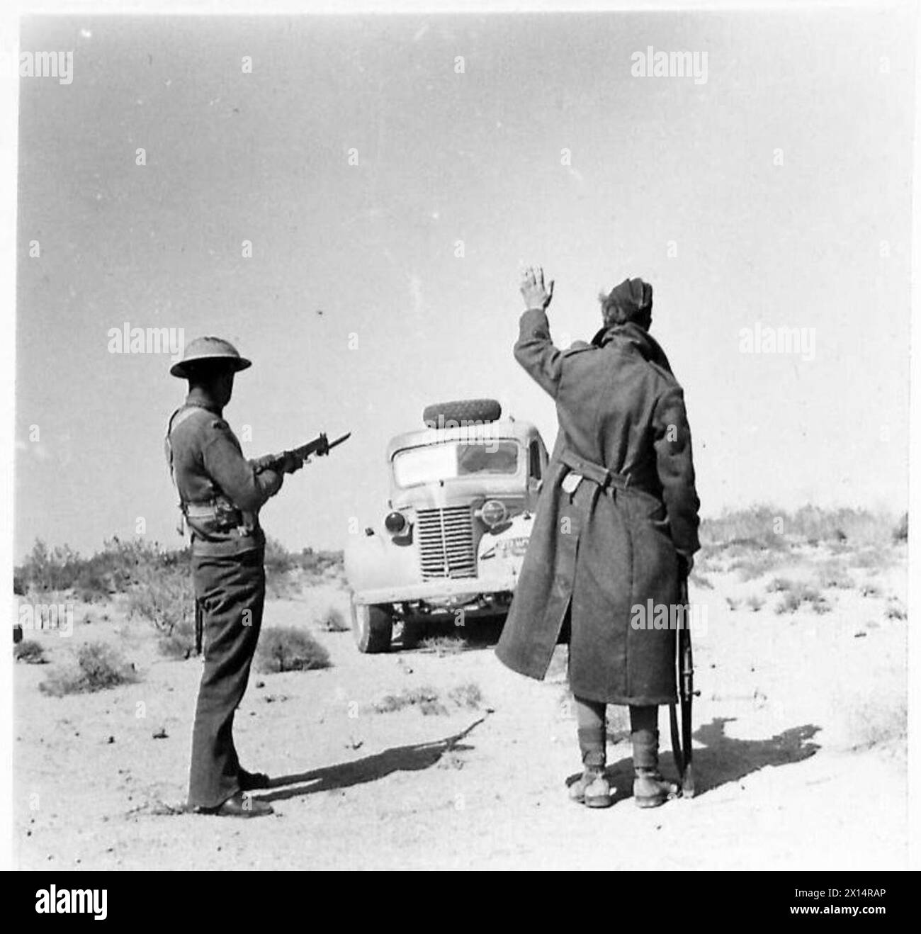 Troops monitor vehicles in the Western Desert, stopping a car for ...
