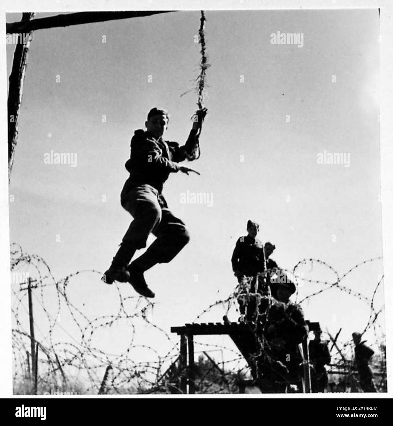 YOUNG SOLDIERS IN TRAINING - One of the lads swings out on a rope from ...