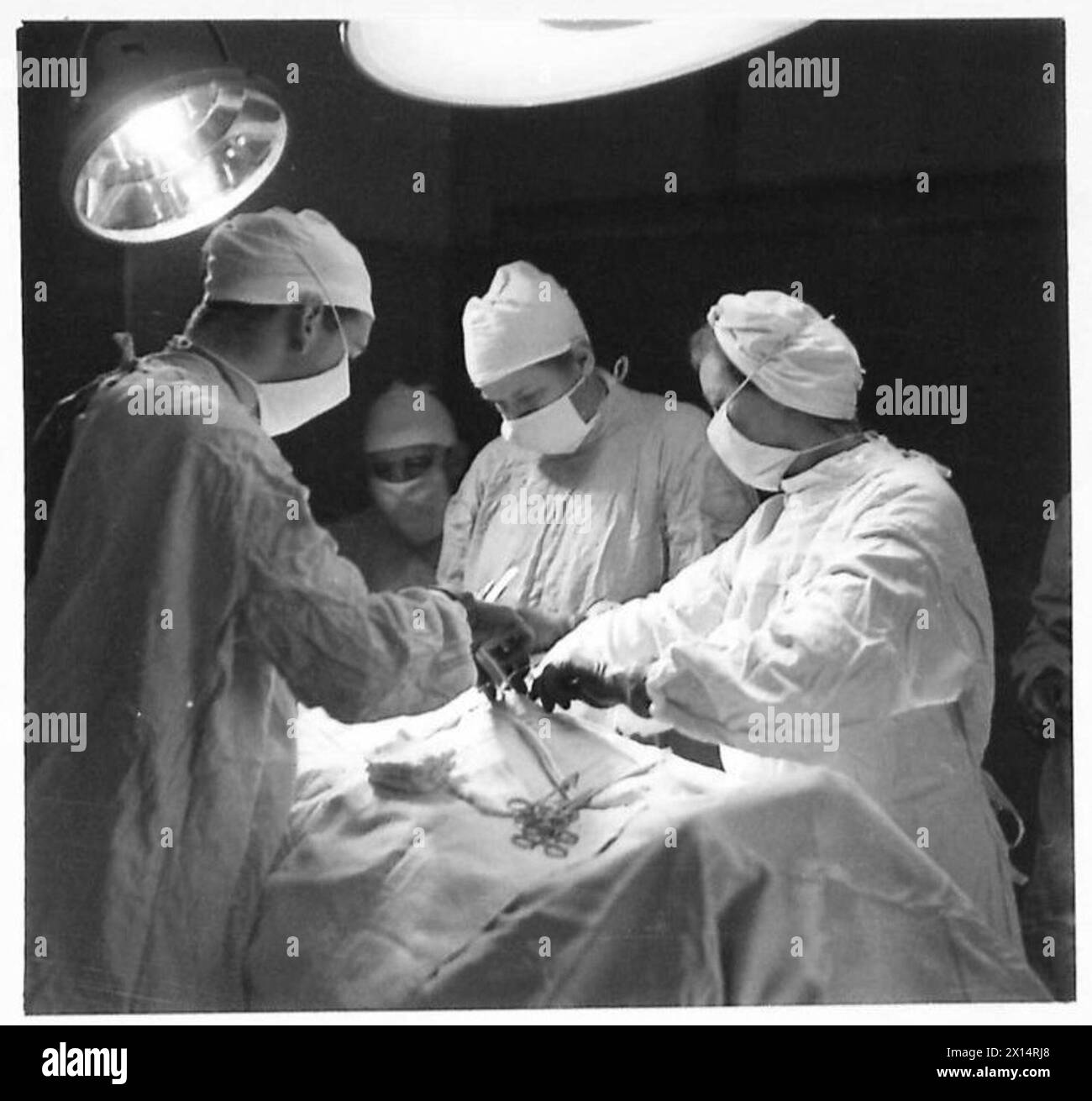 AMERICAN WOMAN SURGEON WITH BRITISH ARMY - The operation begins. Major ...