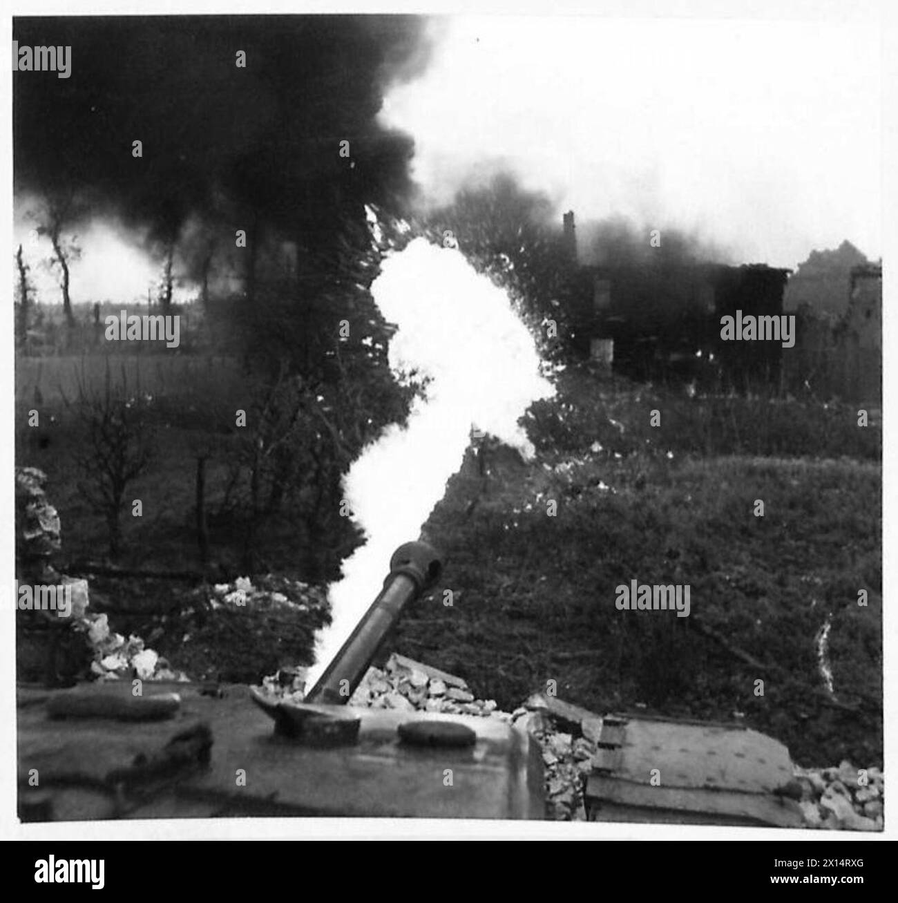 British Crocodile flame-throwing tanks attack a farm house, with one ...
