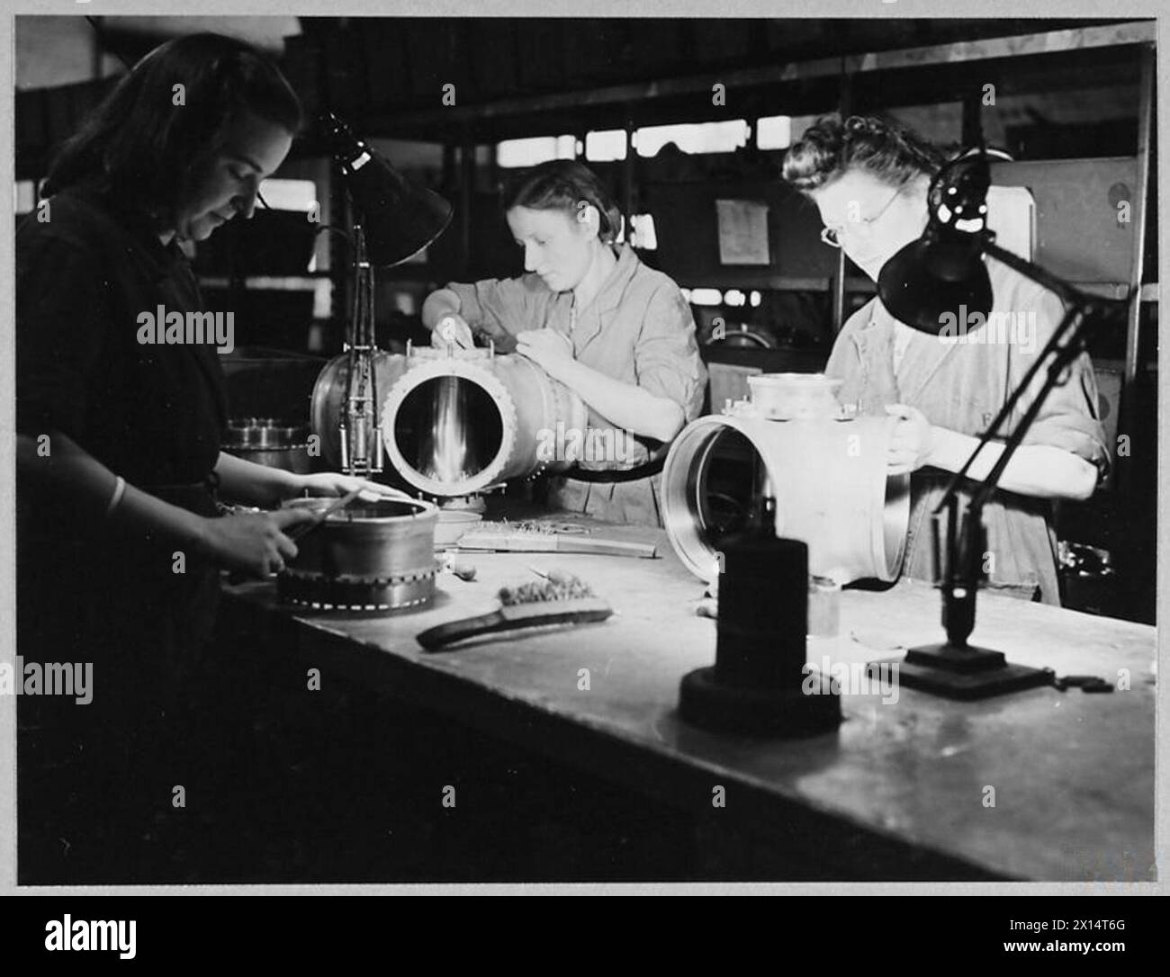 Women workers at a BOAC repair factory clean components of damaged RAF ...