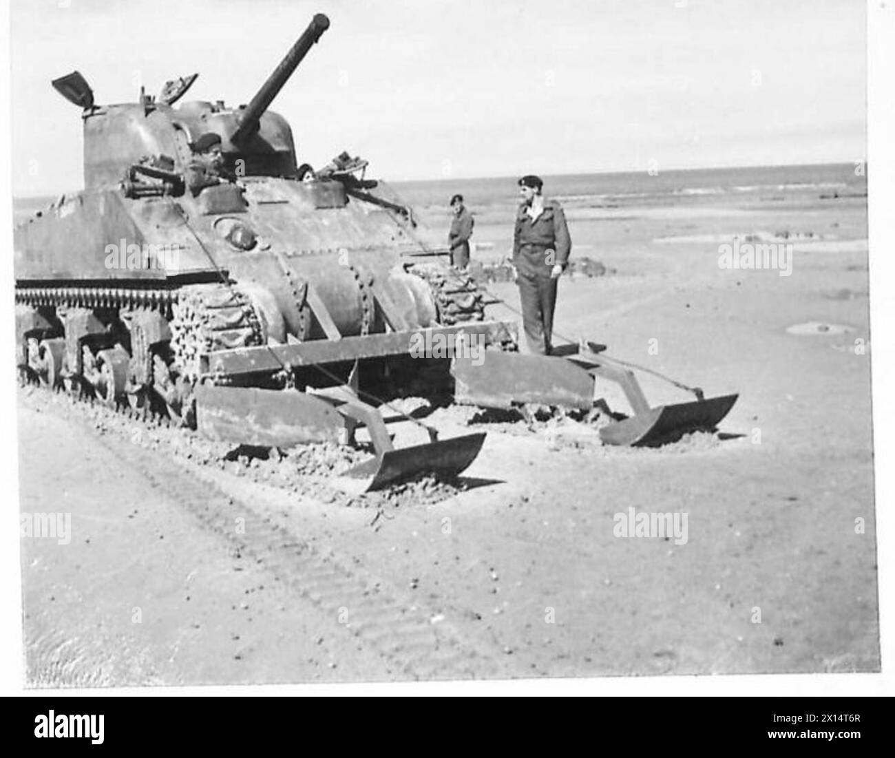 SPECIAL ASSIGNMENT FOR 79TH ARMOURED DIVISION - Side view of tank ploughing. Sherman tank with ...