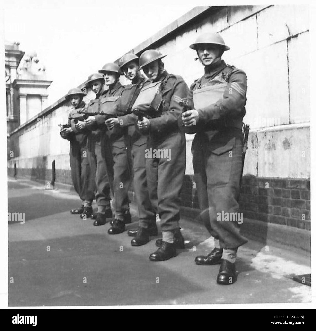 Members of the War Office Defence Staff are armed with Tommy guns under ...