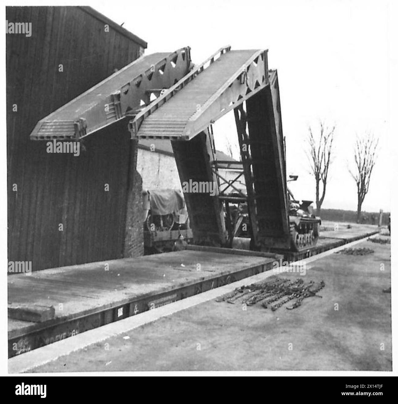 An armoured brigade is practicing bridge-laying for heavy vehicles ...