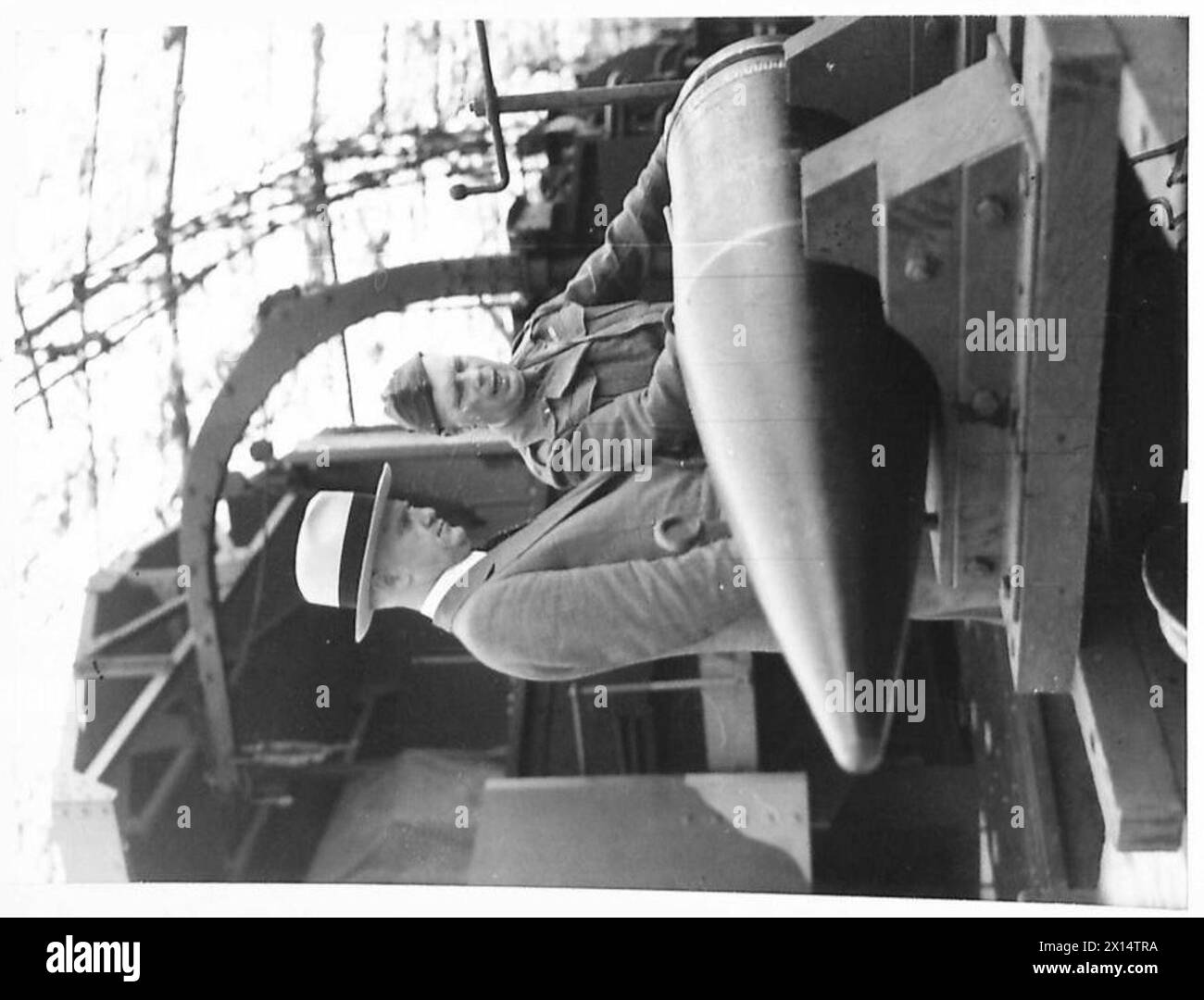 AMERICAN ROTARY PRESIDENT SEES CHANNEL GUN - Mr. Davies examining one ...