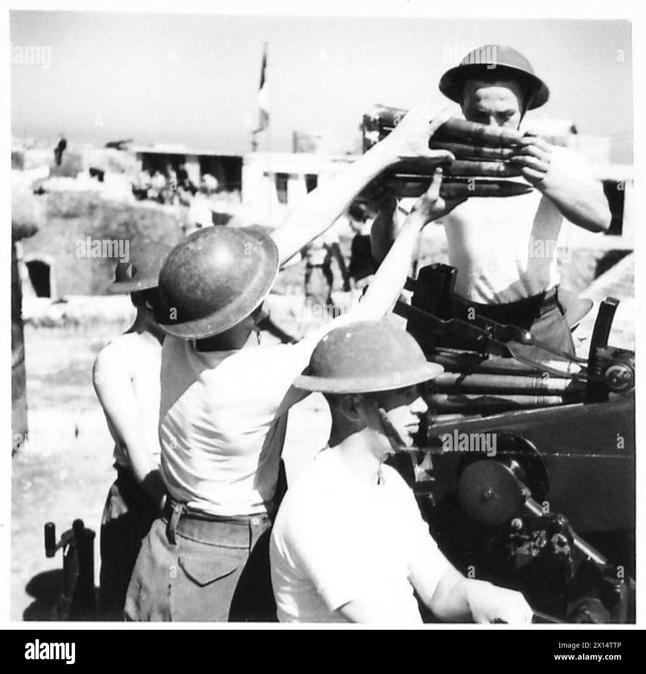 A Bofors anti-aircraft team operates within a fort during an alert ...