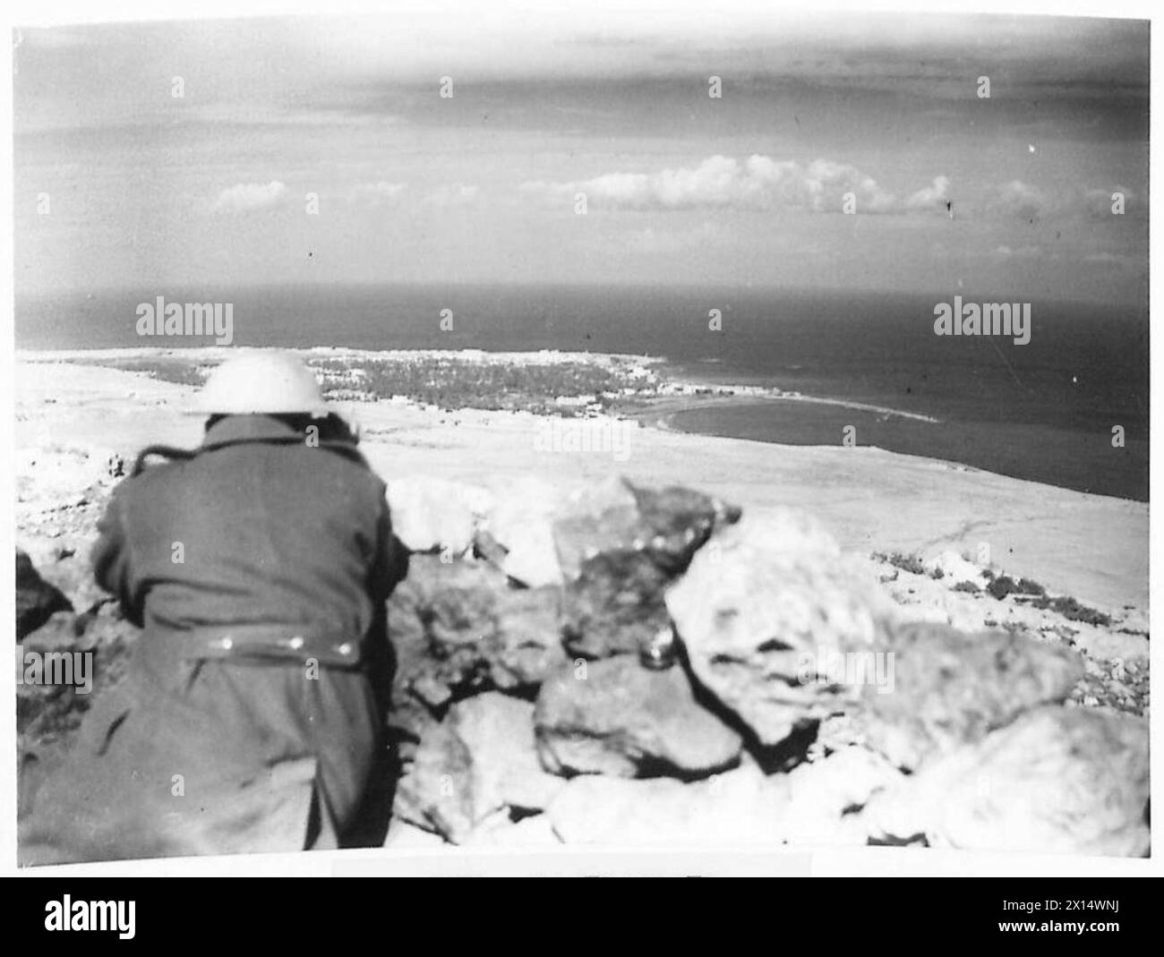 An artillery officer observes the fire of his battery overlooking Derna ...