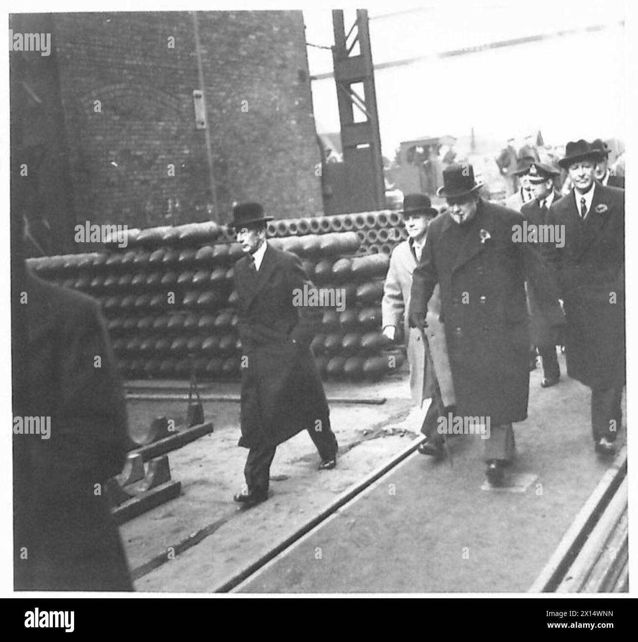 PRIME MINISTER'S TOUR - The Prime Minister passes a pile of shells when ...