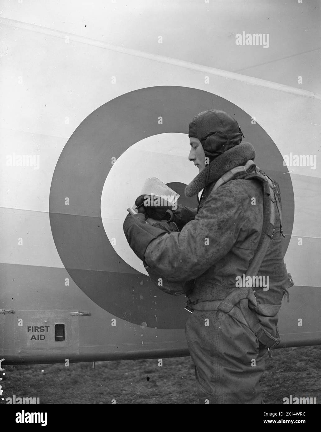 MAN ALIGHTING FROM RAF AIRCRAFT. (1930'S-1940'S). - Man wearing flight ...