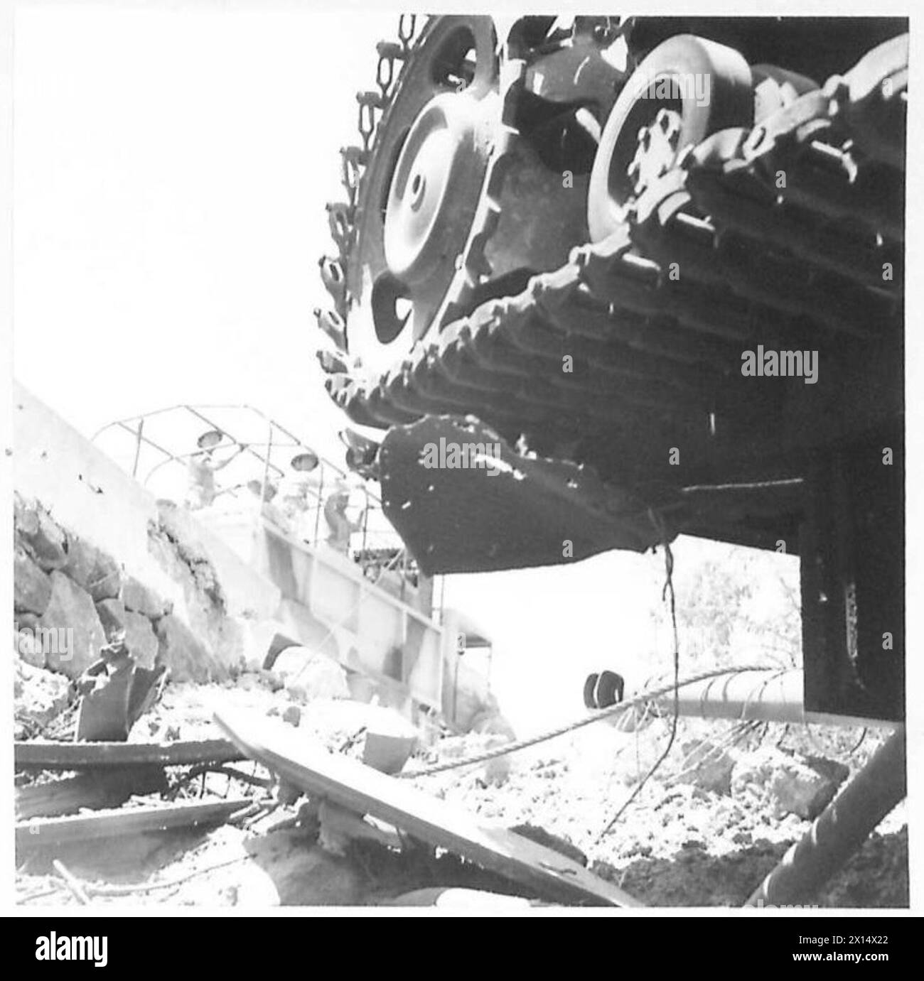 British transport vehicles pass a destroyed German Mk.III tank during ...