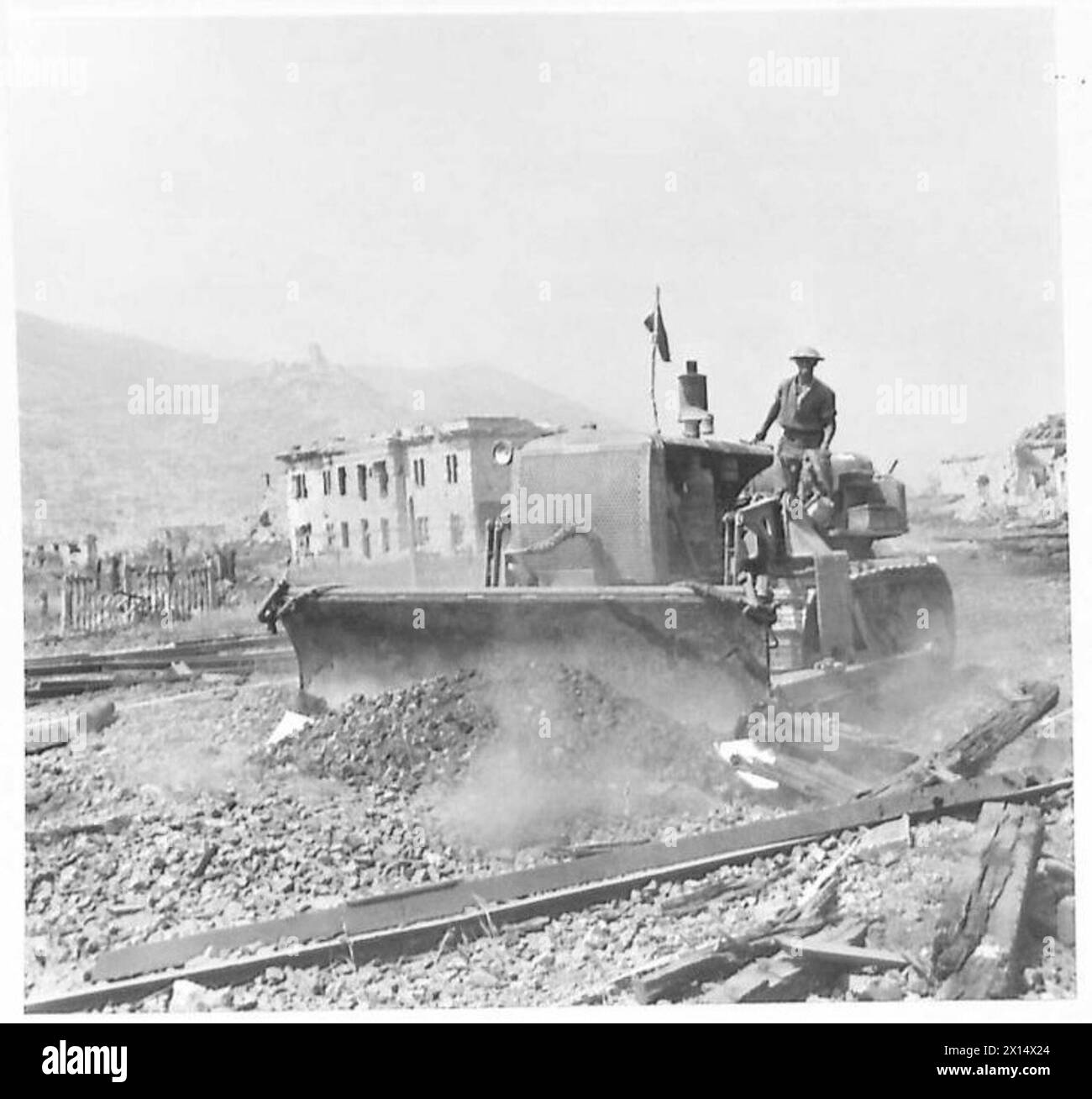 A large bulldozer clears a road in Cassino, Italy, where the railway ...