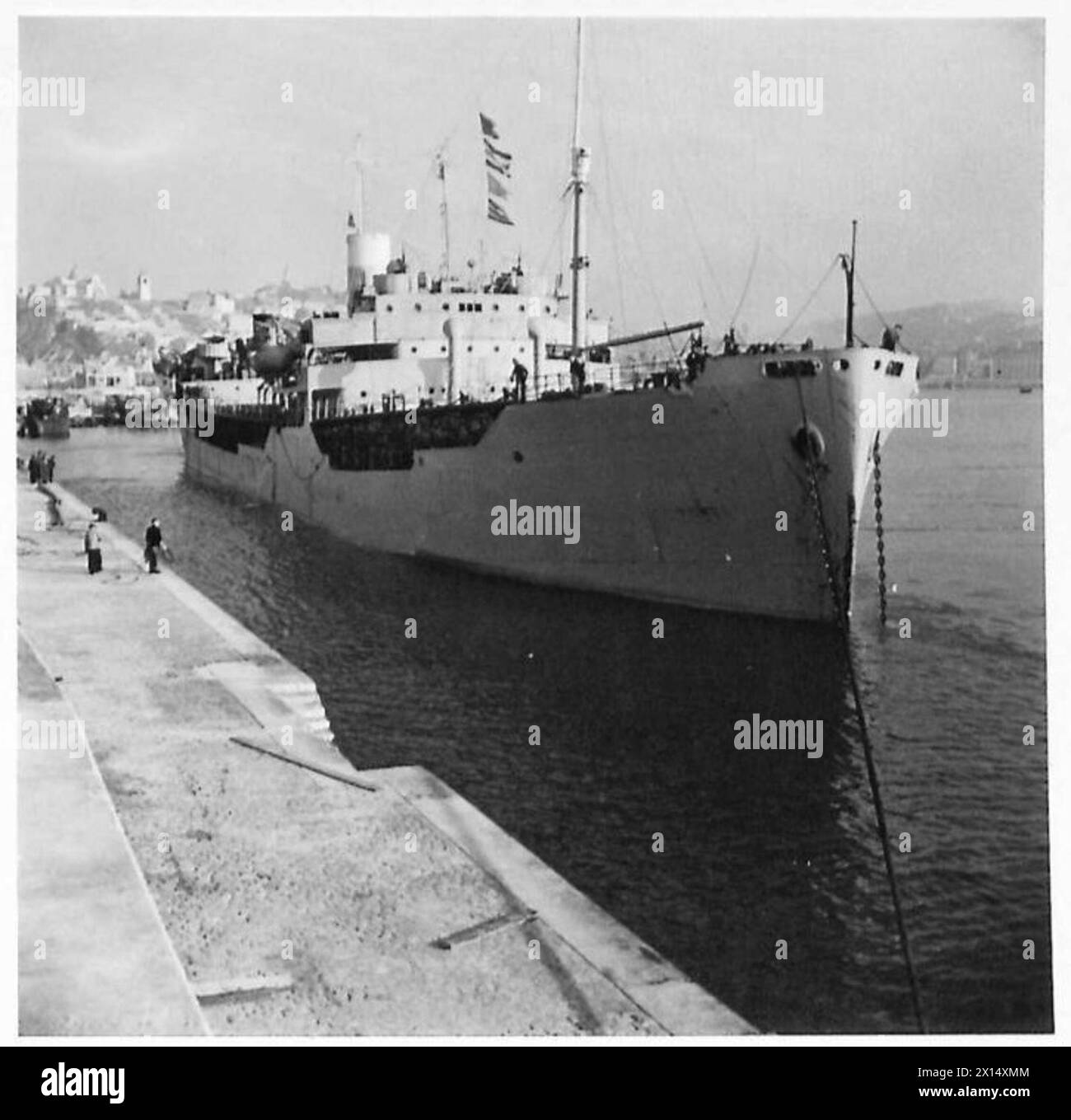 The troopship Empire Emerald docks at Ancona harbor, transporting ...