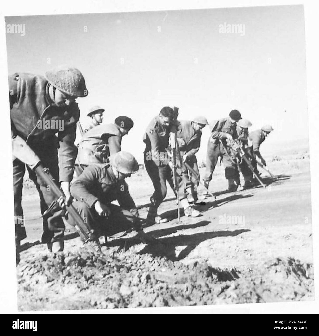 Men of the 8th Field Squadron, Royal Engineers, probe the heavily mined ...