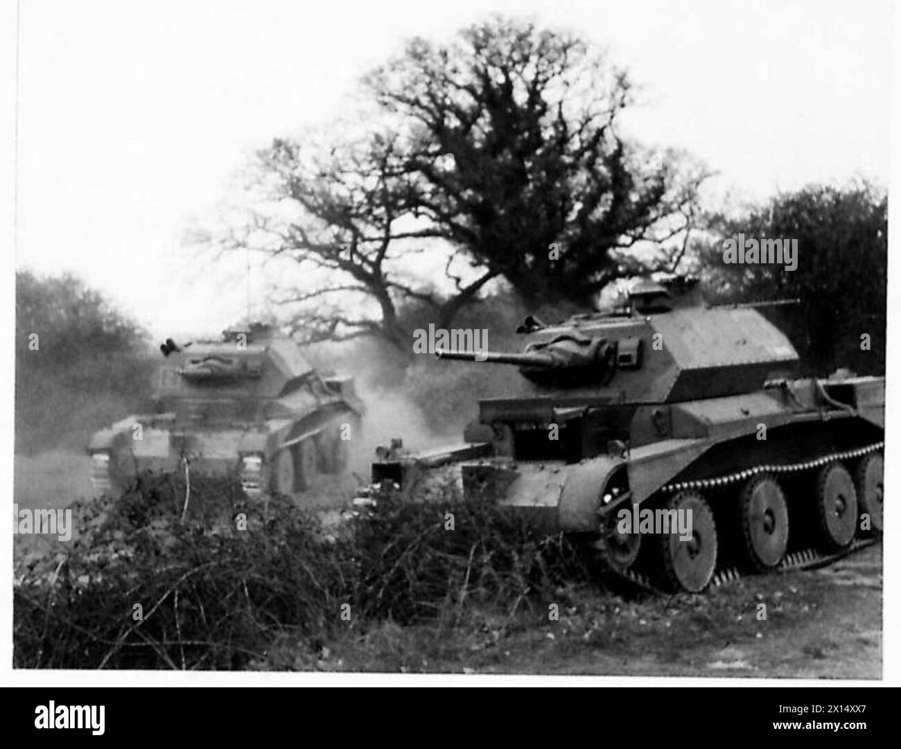 TANKS IN ACTION - Cruiser tanks emerging from a small wood during the ...