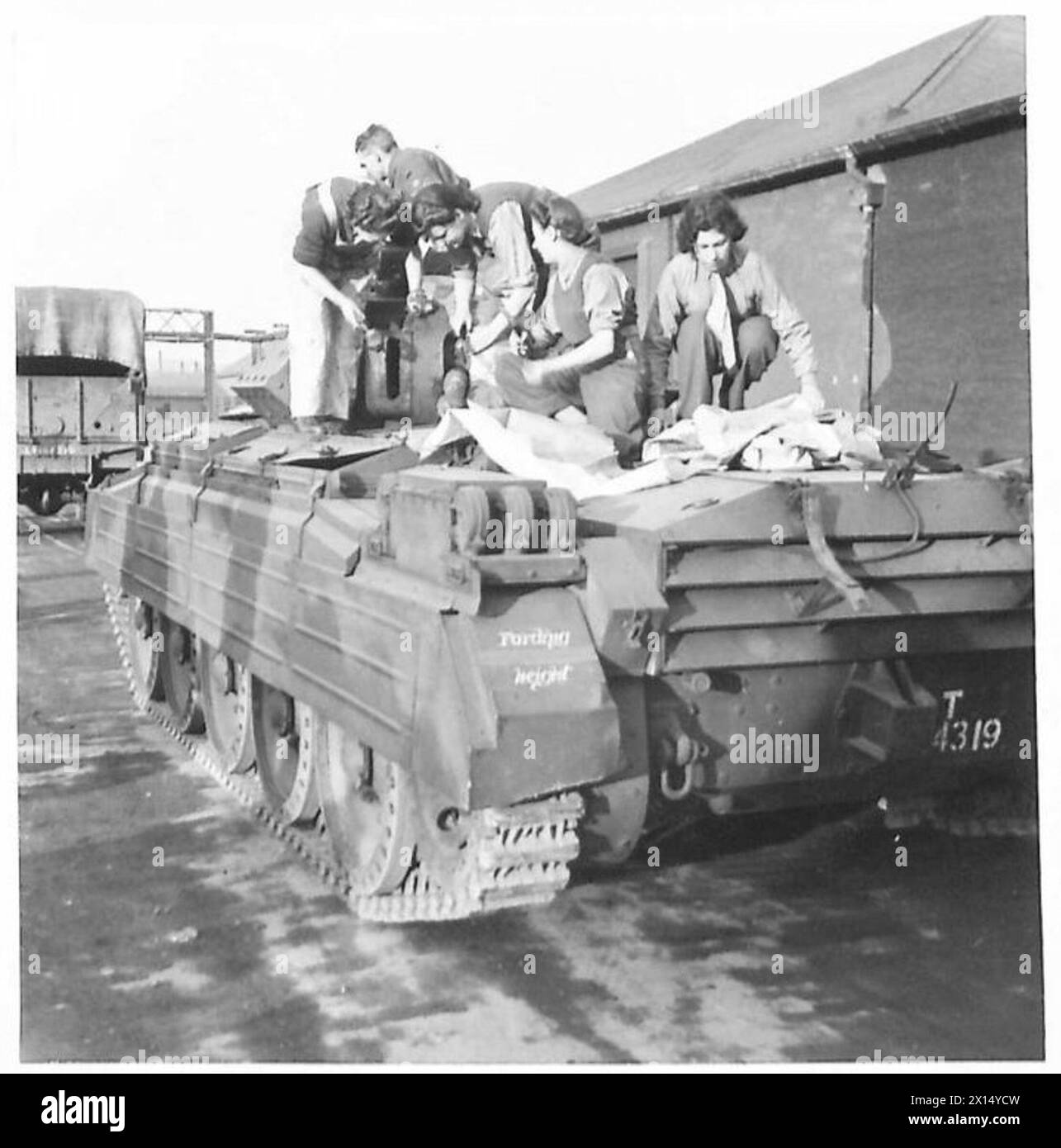 British Army ATS personnel cutting balloon fabric strips to seal tank ...