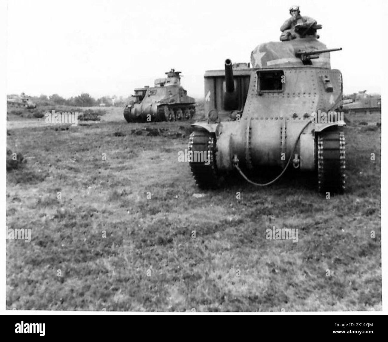 American tanks participate in combined operations, moving into action over the moors under ...