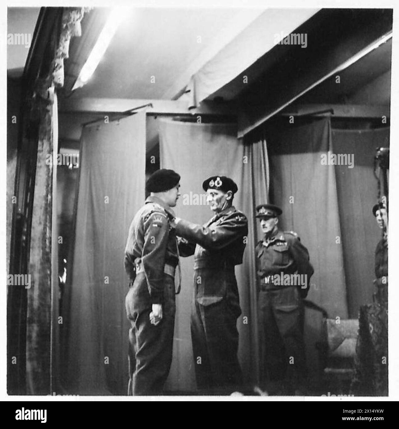 Capt. J.E. Reynolds of the 53rd Reconnaissance Regiment receives the ...
