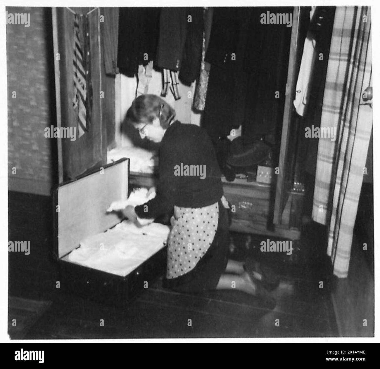 THE EVACUATION OF A VILLAGE - A civilian woman packs her belongings ...