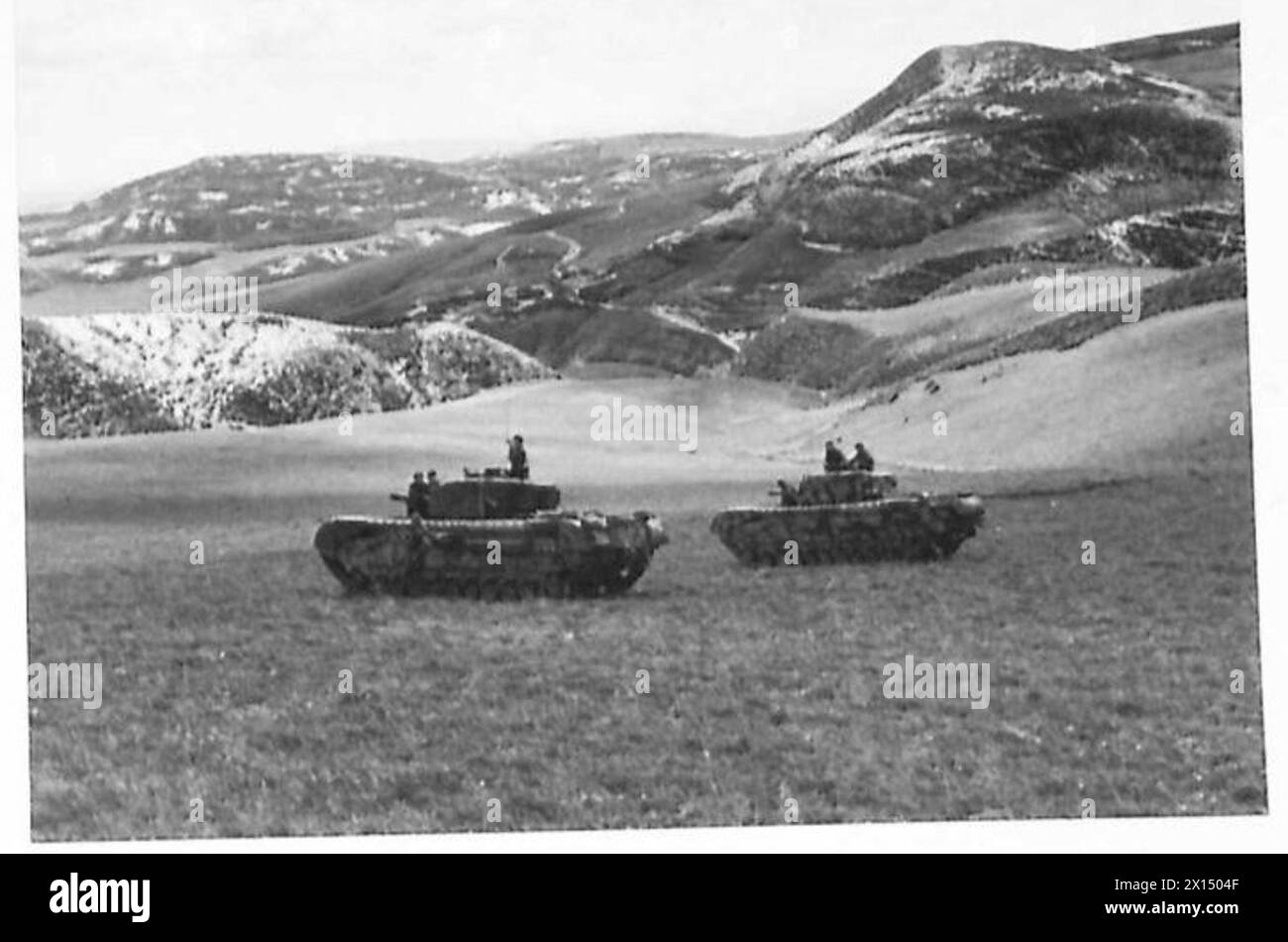 Two tanks from the First Army are shown approaching steep and difficult ...