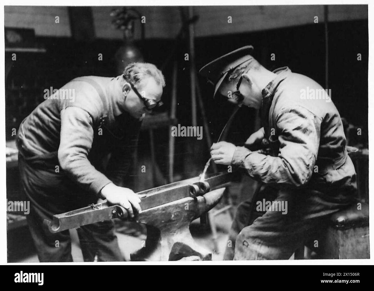 SOLDIERS AND CIVILIANS REPAIR ARMY EQUIPMENT - A civilian watches a ...