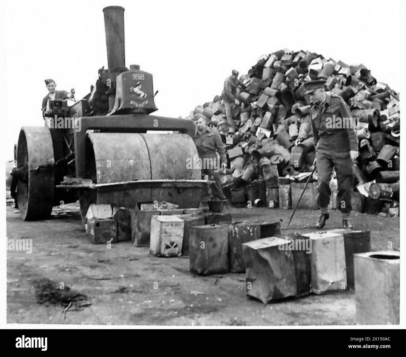 Soldiers work at a salvage dump handling discarded or reusable ...