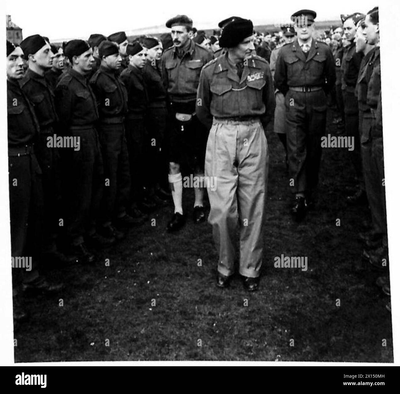 General Montgomery walks through the ranks of R.E.M.E. at Fort George ...